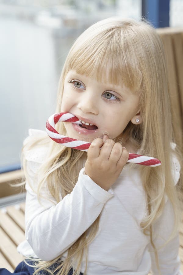 Blonde Little Girl Singing into a Small Flashlight Like into a ...