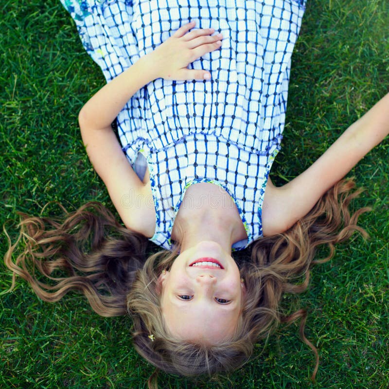 Happy Little Girl Having Fun Lying on Grass Stock Photo - Image of ...