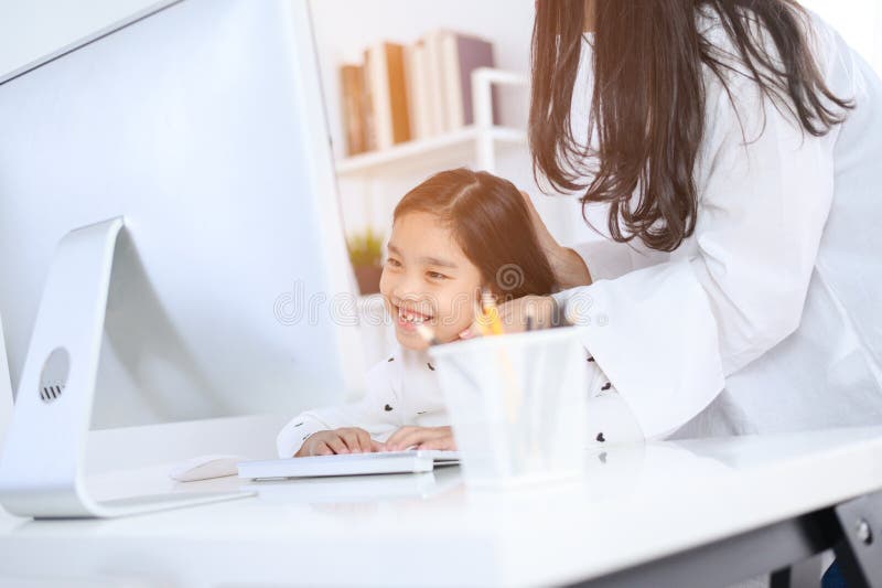 Happy Little Girl Looking at Computer with Her Mother Stock Image ...