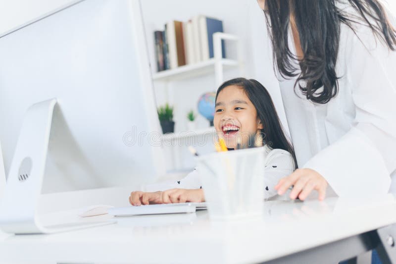 Happy Little Girl Looking at Computer with Her Mother Stock Image ...