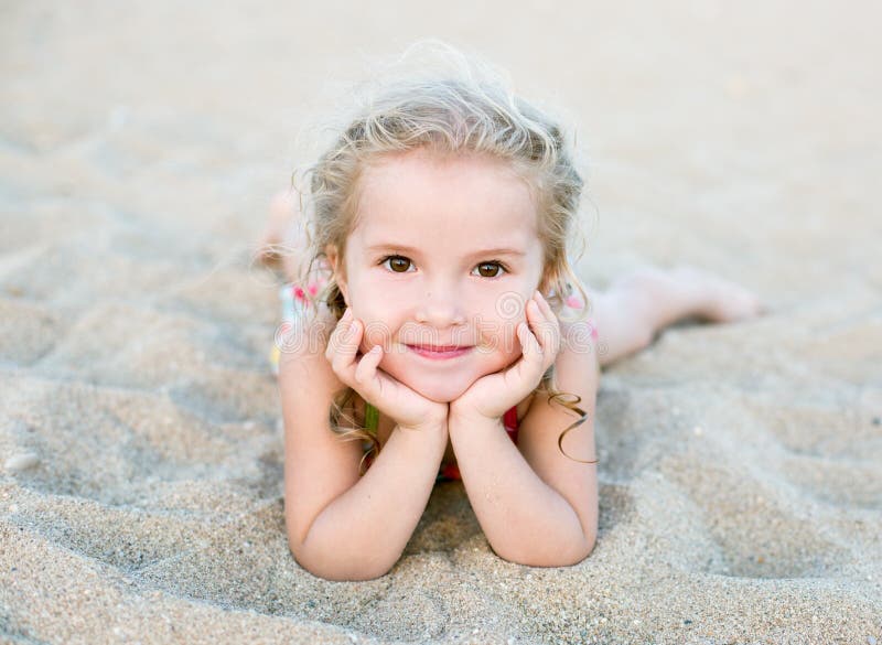 Six Year Old Girl Lying on the Sand on the Beach Stock Photo - Image of ...
