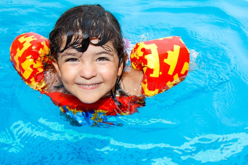 Happy little girl in pool stock photo. Image of bathing - 25884130