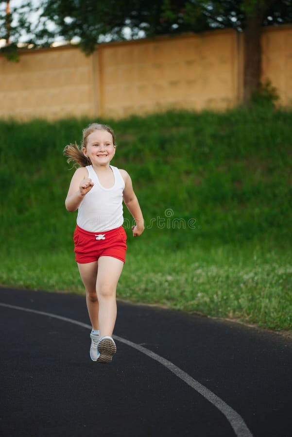 Happy Little Girl Running on the Stadium Stock Photo - Image of running ...