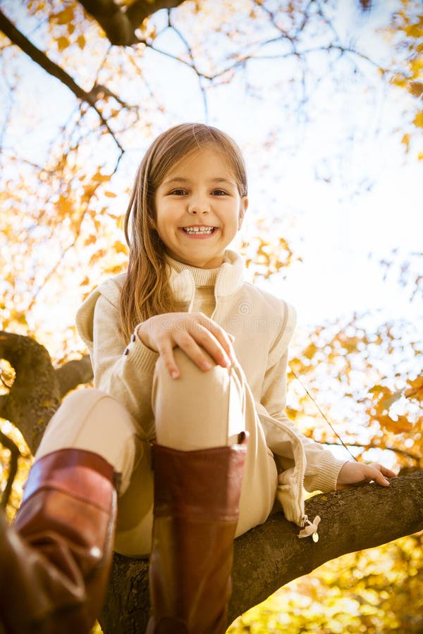 Happy Little Girl Sitting on a Tree Trunk Stock Image - Image of ...
