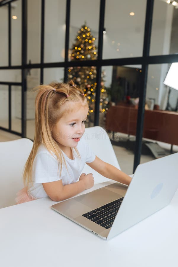 Little Girl Using Tablet Computer Sitting at Table Stock Image - Image ...