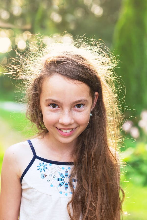 The Happy Teen Girl Standing and Smiling Against Green Background ... The Happy Teen Girl Standing and Smiling Against Green Background ...