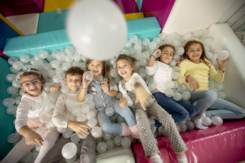 Happy Little Kids in Ball Pit Smiling Happily at Camera while Having ...