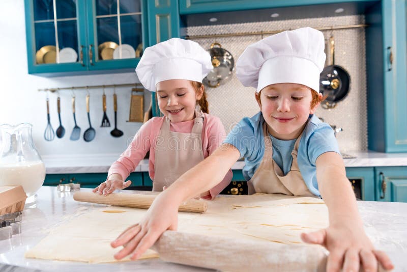 Happy Little Kids in Chef Hats and Aprons Rolling Dough Stock Image ...