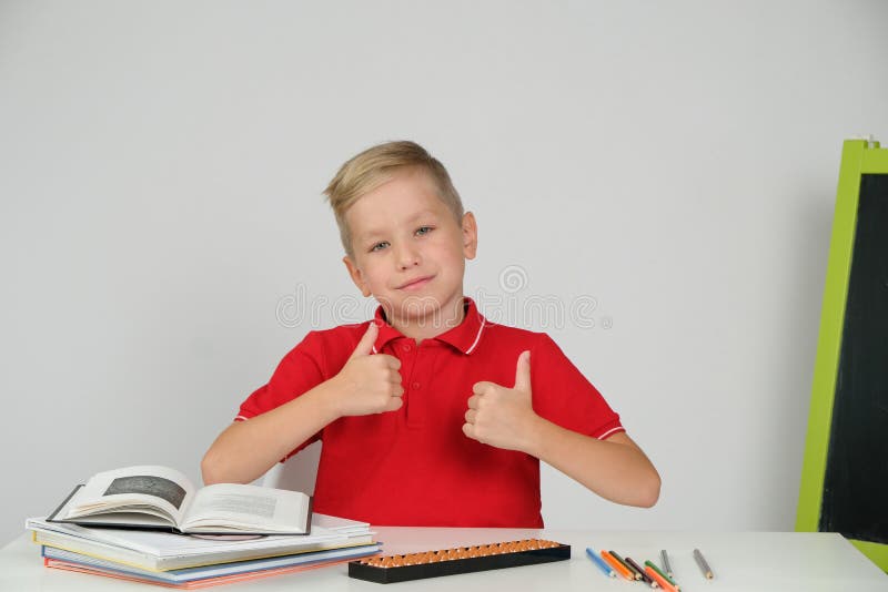 Happy Little School Boy Feeling Satisfied Doing School Homework at the ...