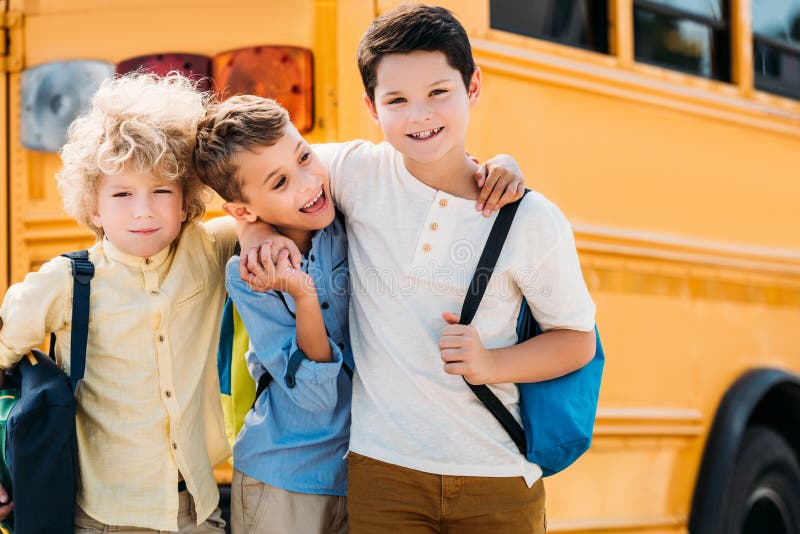 Happy Little Schoolboys Embracing in Front of School Stock Image ...