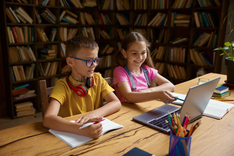 Happy Little Schoolchildren Studying Together Using Laptop Stock Image ...