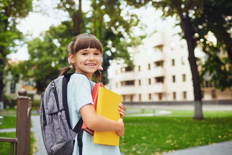 Happy Little Student Girl with a Backpack on Her Way To School. Stock ...