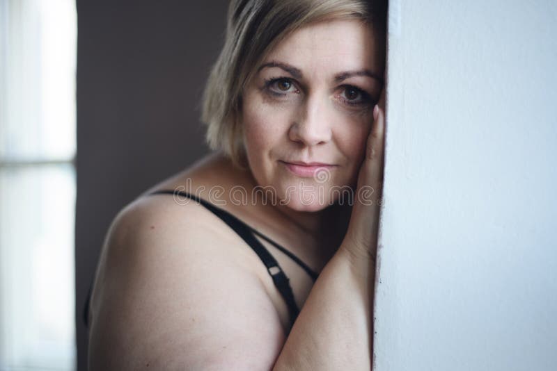 Happy Lonely Fat Woman In Underwear Posing And Looking At Camera Stock