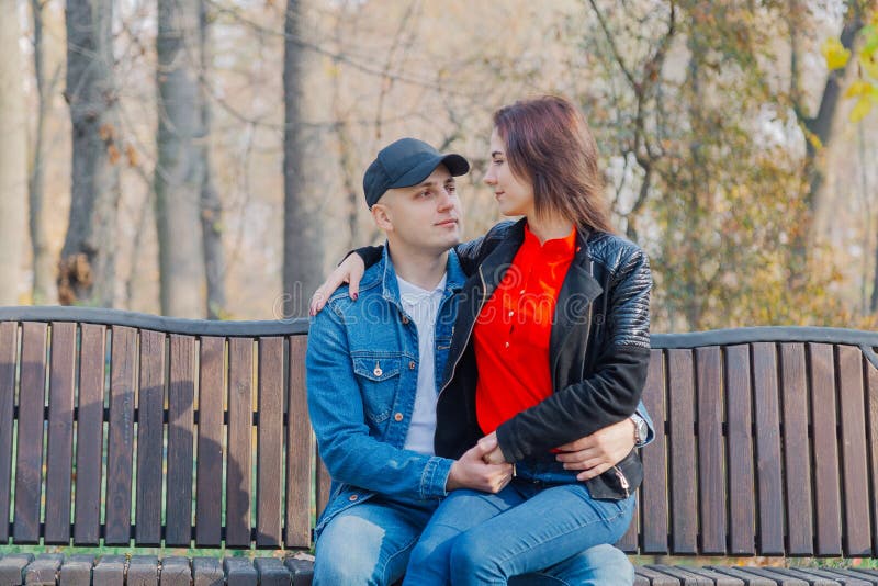 Happy Lovers in the Park on a Bench in Autumn. Stock Photo - Image of ...