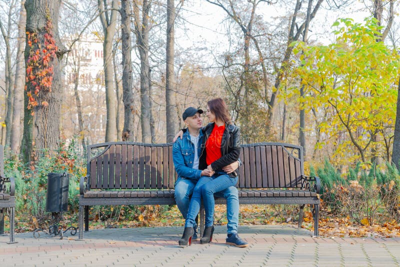 Happy Lovers in the Park on a Bench in Autumn. Stock Photo - Image of ...