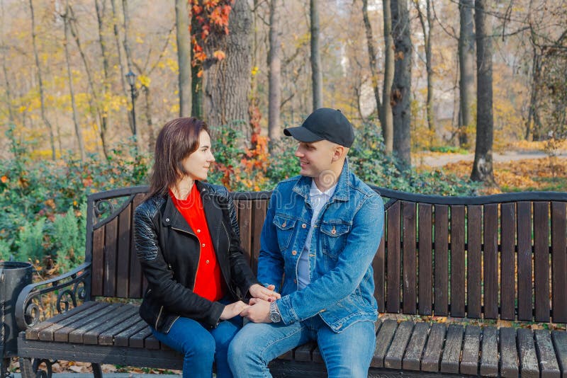 Happy Lovers in the Park on a Bench in Autumn. Stock Photo - Image of ...
