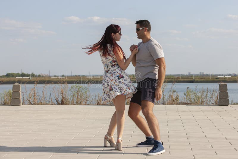 Happy Loving Couple Embracing and Kissing Outdoors at Summertime Under ... Happy Loving Couple Embracing and Kissing Outdoors at Summertime Under ...