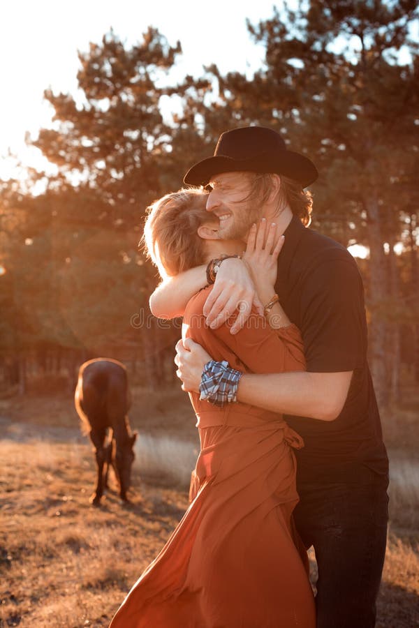 .happy and Loving Couple in the Setting Sun on a Horse Farm- Image ...