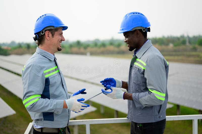 Happy Maintenance Engineers Checking and Maintaining Solar Panels Stock ...