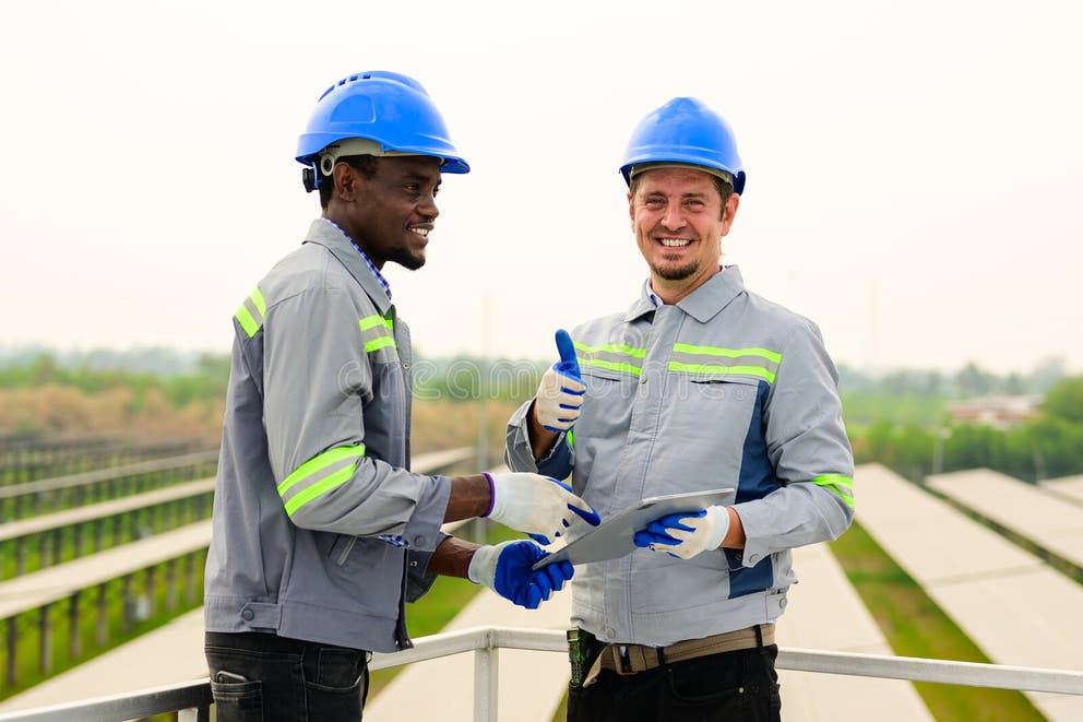 Happy Maintenance Engineers Checking and Maintaining Solar Panels Stock ...