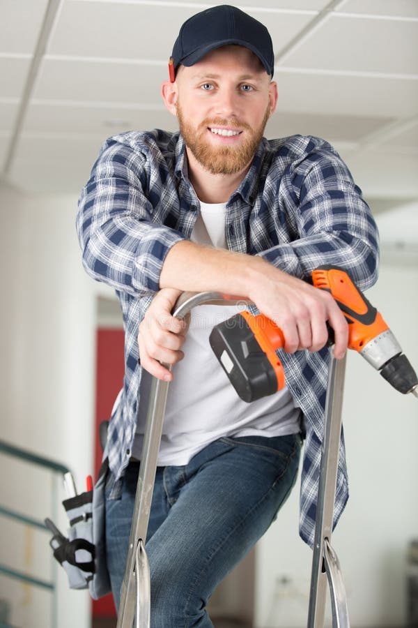Happy Male Builder Standing on Ladder with Drill Stock Image - Image of ...
