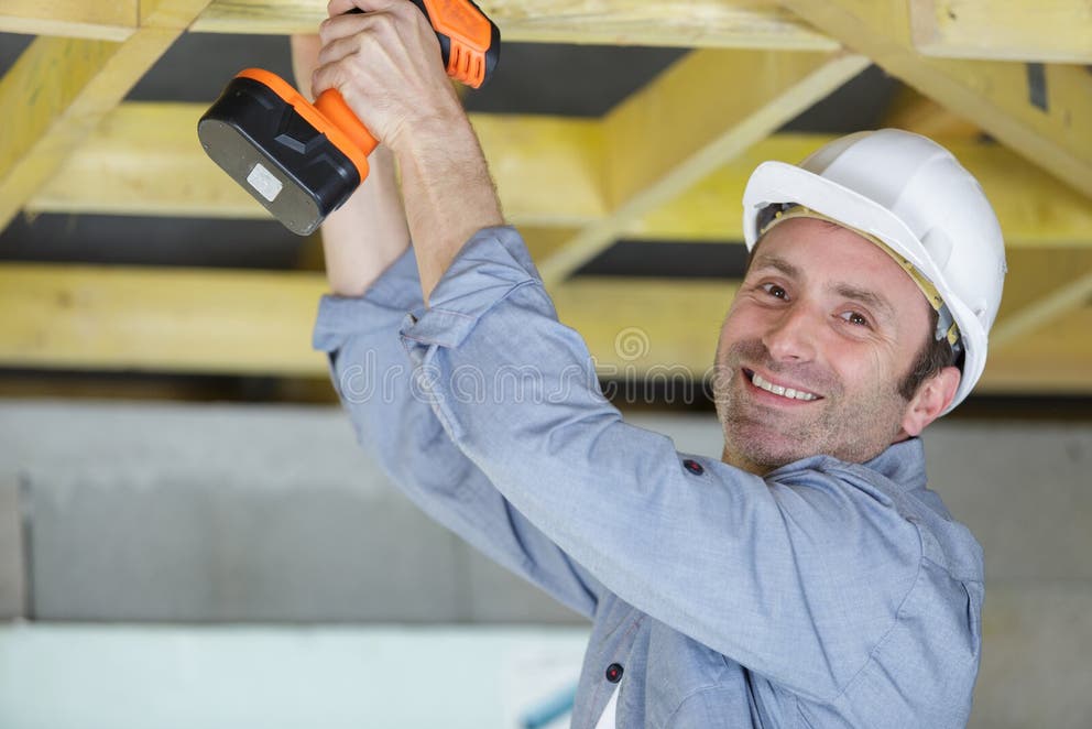 Happy Male Builder Working on Ceiling Stock Photo - Image of ...