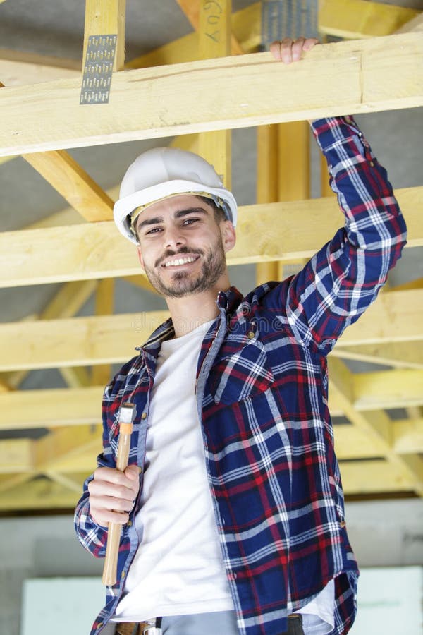 Happy Male Builder Working on Wooden Structure Stock Image - Image of ...