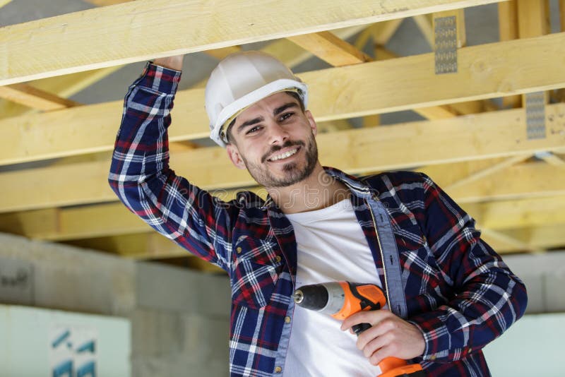 Happy Male Construction Worker Adjusting Ceiling Stock Image - Image of ...