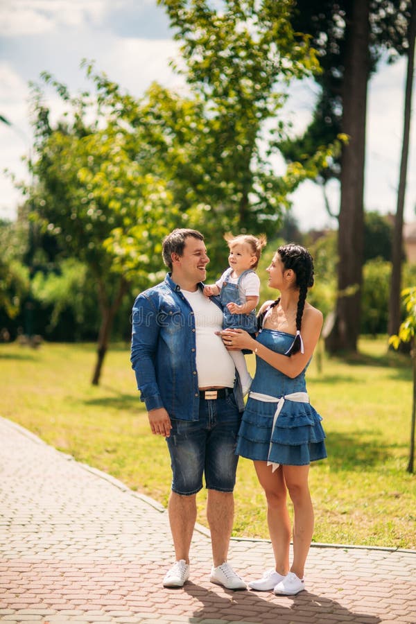 Happy Male and Female Playing with Child Outside Stock Image - Image of ...