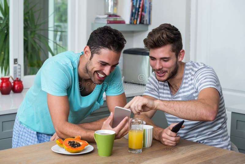 Happy Male Friends Using Phone Stock Image - Image of home, fondness ...