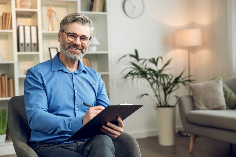 Happy Male Psychologist with Clipboard Looking at Camera and Smiling ...
