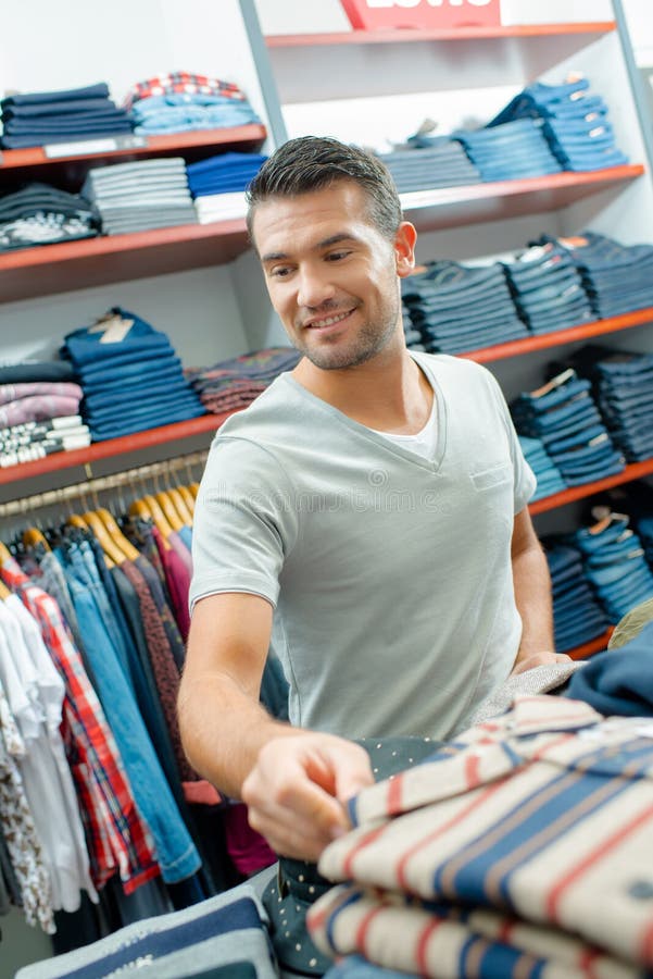 Happy male shop worker stock photo. Image of spending - 234517846