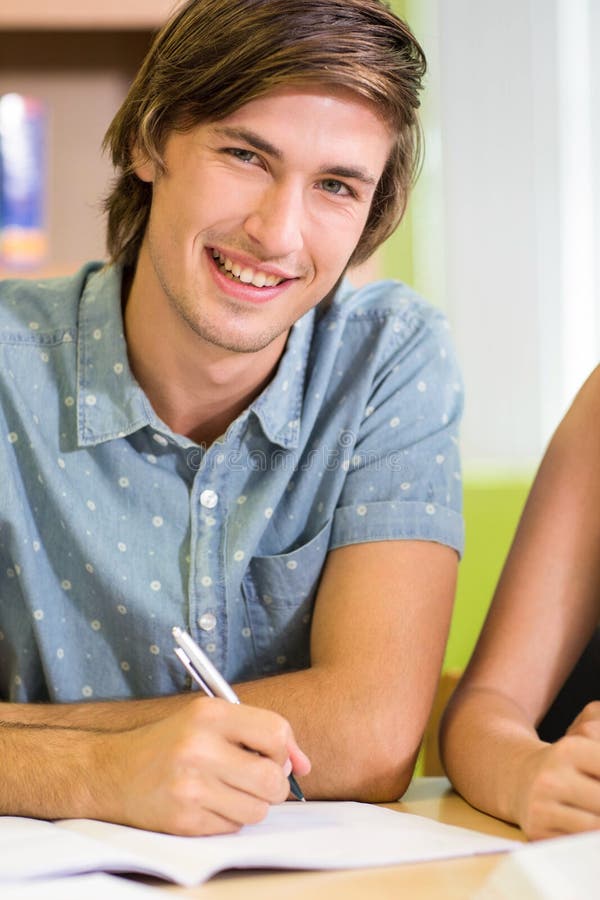 Happy Male Student Doing Homework in Library Stock Image - Image of ...