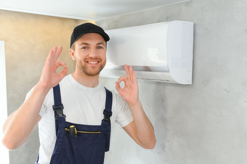 Happy Male Technician Repairing Air Conditioner. Stock Photo - Image of ...