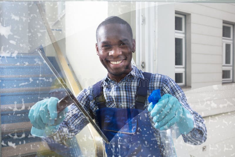Male Worker Cleaning Glass with Squeegee Stock Image - Image of ...