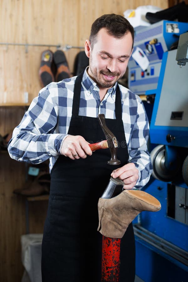Male worker repairing shoe stock image. Image of amend - 228925103