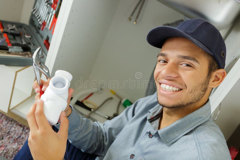 Happy Male Worker in Workshop Stock Photo - Image of displaying ...