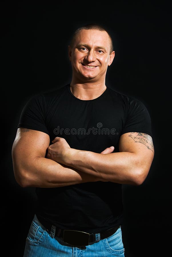 Man Posing in Black T-shirt and Black Hat. Stock Photo - Image of light ...