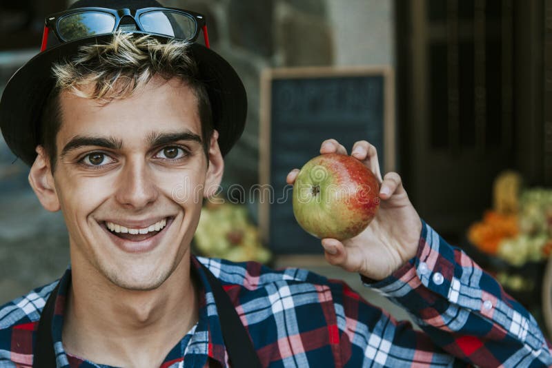 Happy man with apple stock image. Image of store, latin - 78994823