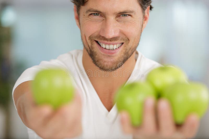Happy man with apples stock image. Image of nutrition - 258029681