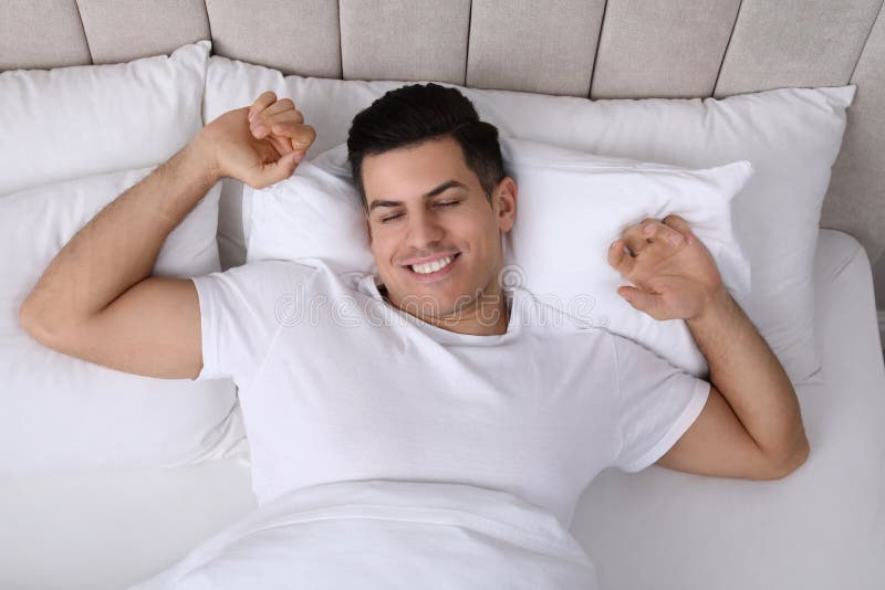 Happy Man Awakening in Bed at Home, Top View Stock Image - Image of ...