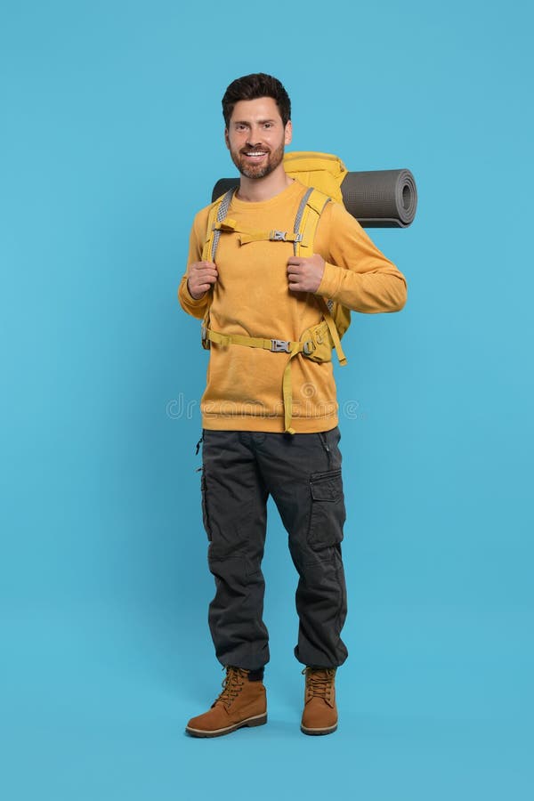 Man with Backpack on Light Blue Background. Active Tourism Stock Photo ...