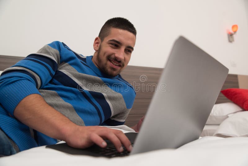 Happy Man in Bedroom with Laptop Stock Photo - Image of relax, pillow ...