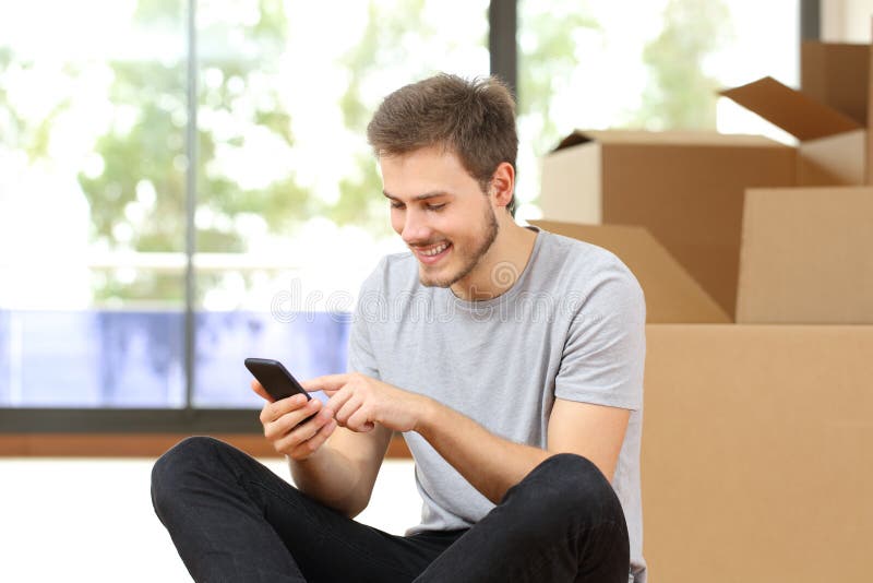 Happy Man with Boxes Using Phone Moving Home Stock Image - Image of ...
