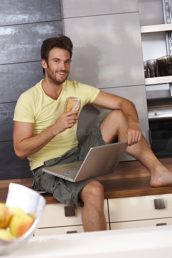 Happy Man Browsing Internet in Kitchen Stock Image - Image of color ...