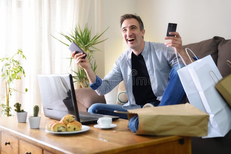 Happy Man Buying Online at Home from Electronic Devices Stock Image ...
