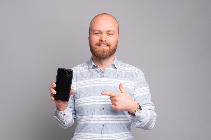 Happy Man in Casual Pointing at Phone Screen and Smiling Stock Photo ...