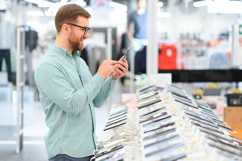 Happy Man Chooses Mobile Phone in Electronics Store Stock Photo - Image ...