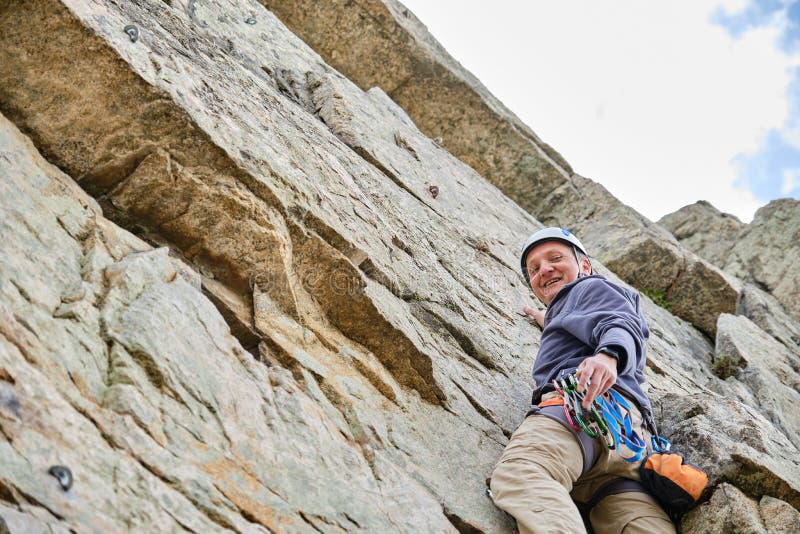 A Happy Man Climbing a Rock Wall Stock Image - Image of mature ...