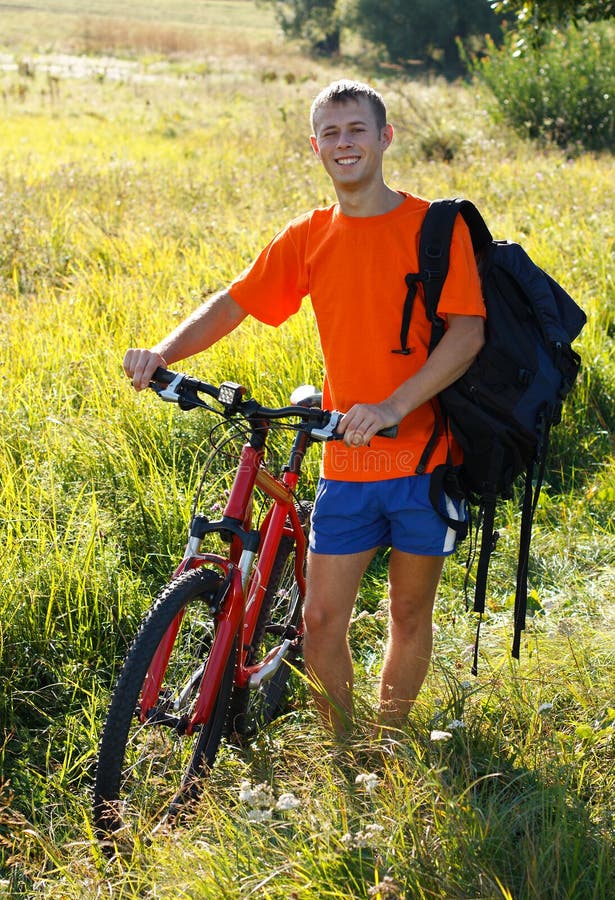 Happy Cyclist Enjoying Relaxation Lying Barefoot in Green Grass Stock ...